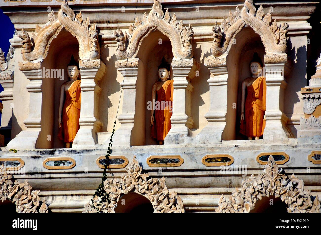 Chiang Mai, Thailand: Statues of standing Buddhas in orange robes stand ...