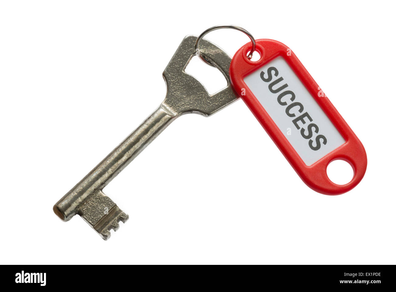 Old key with red label with text success against a white background ...