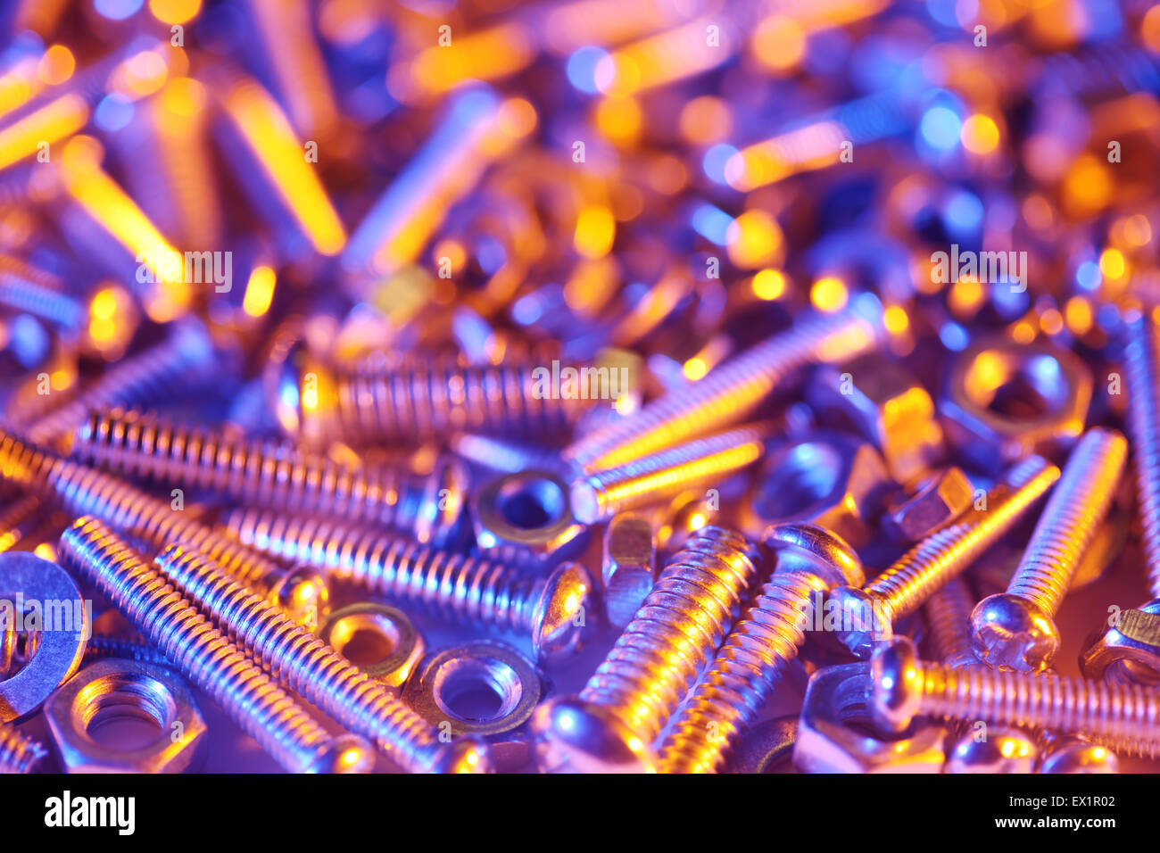 Nuts and bolts background in bright colorful lights Stock Photo - Alamy