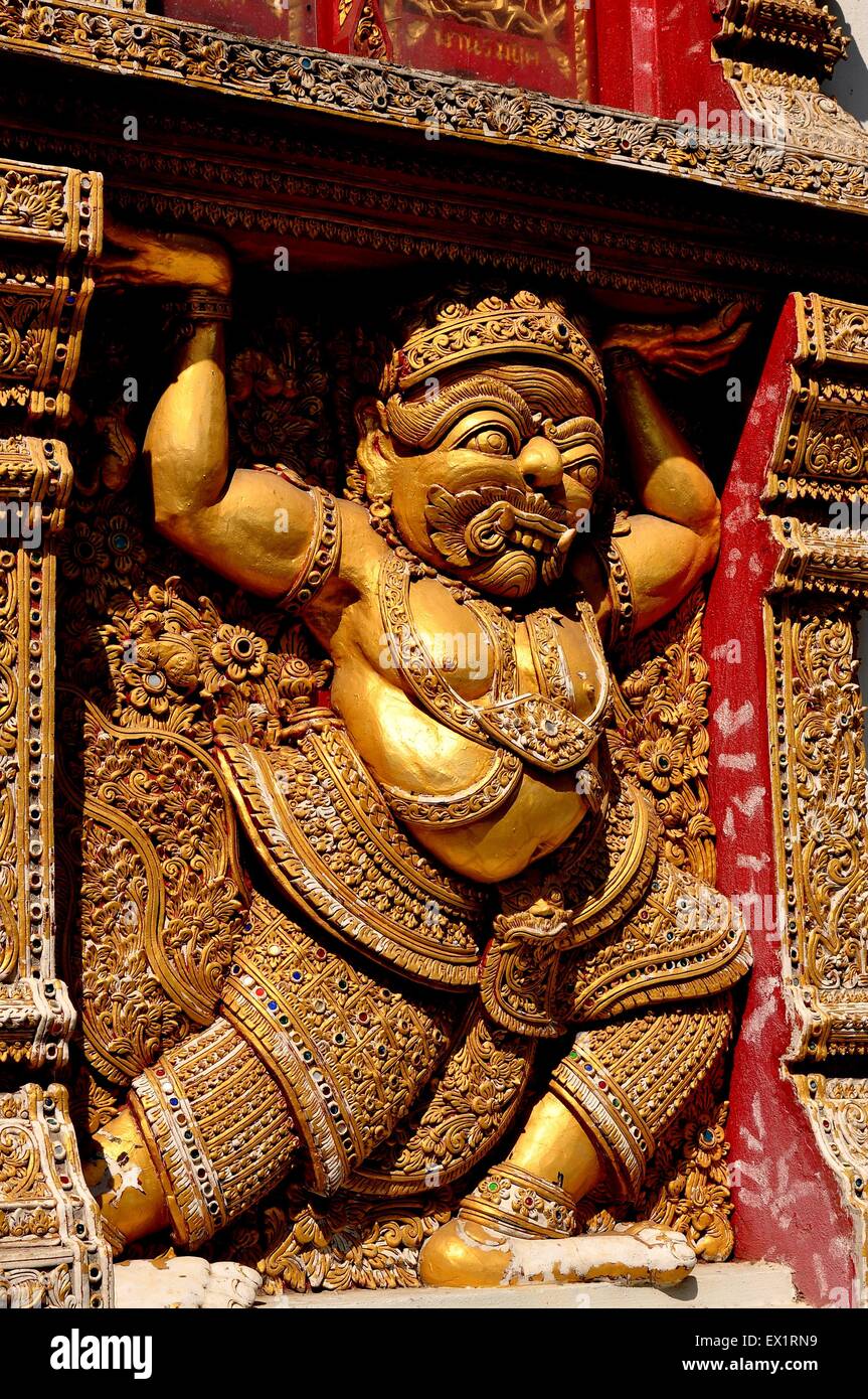 Chiang Mai, Thailand: Gilded figure of a mythical man holding up a ...