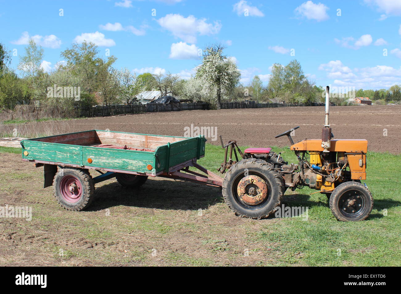 old tractor with trailer in the village Stock Photo - Alamy