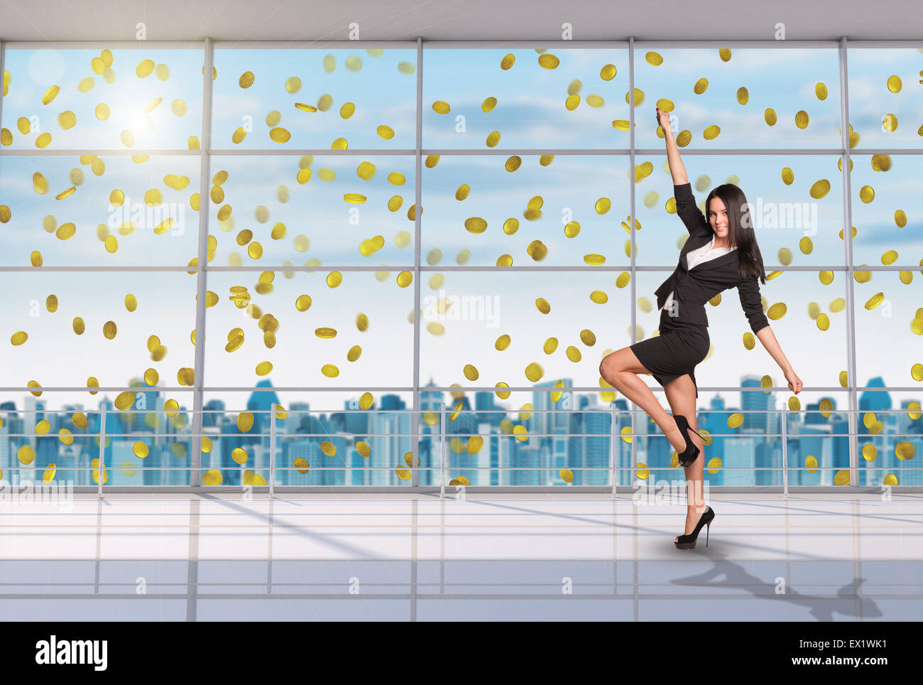 Businesswoman in winner posture under money rain Stock Photo - Alamy