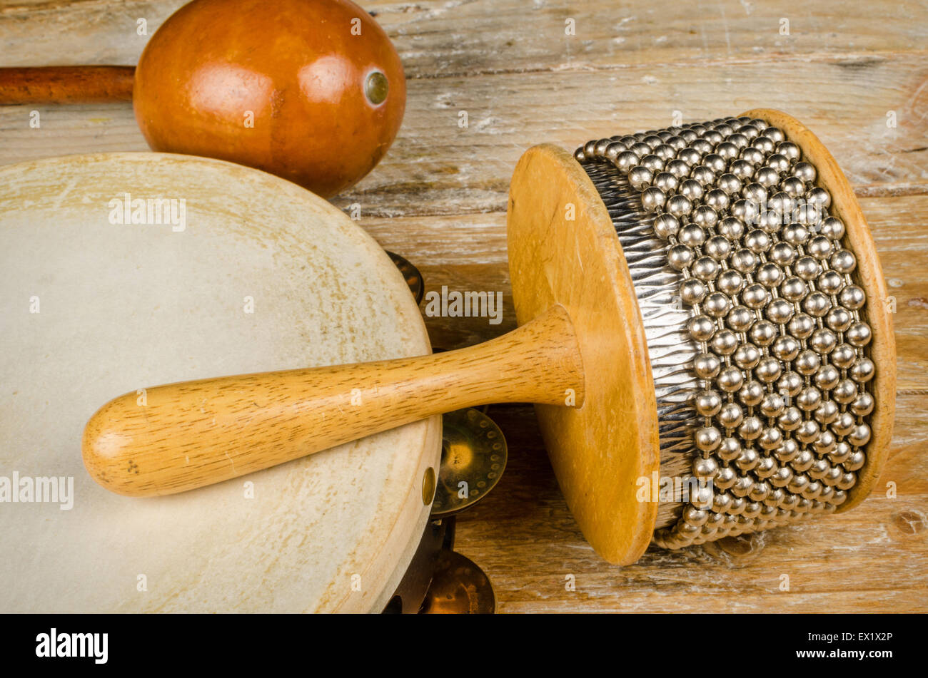 Several small percussion instruments on a rustic wooden surface Stock ...