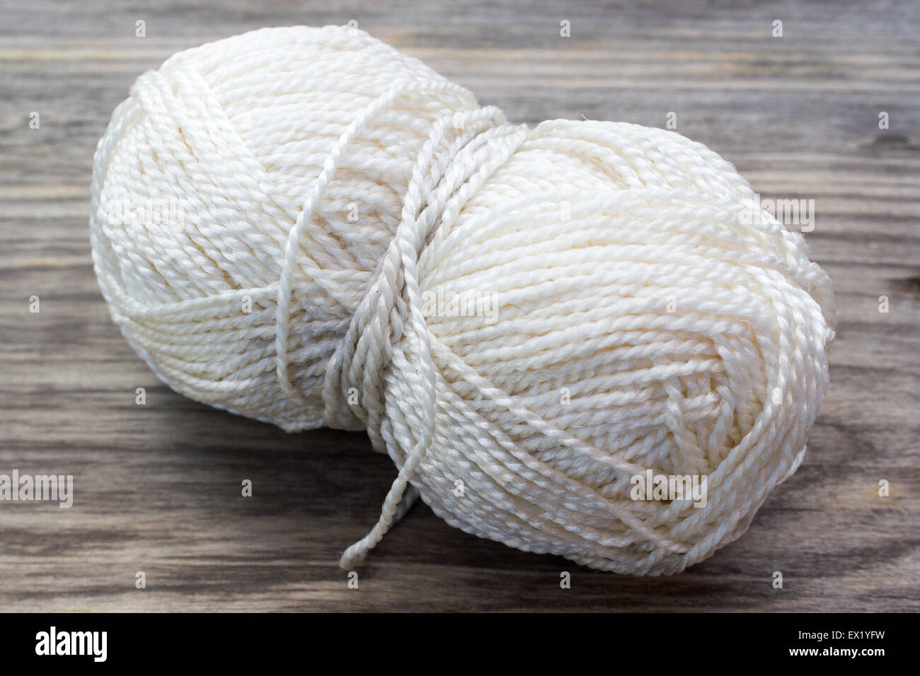 White Rope and Textured Wood, Coil of white rope set against highly ...