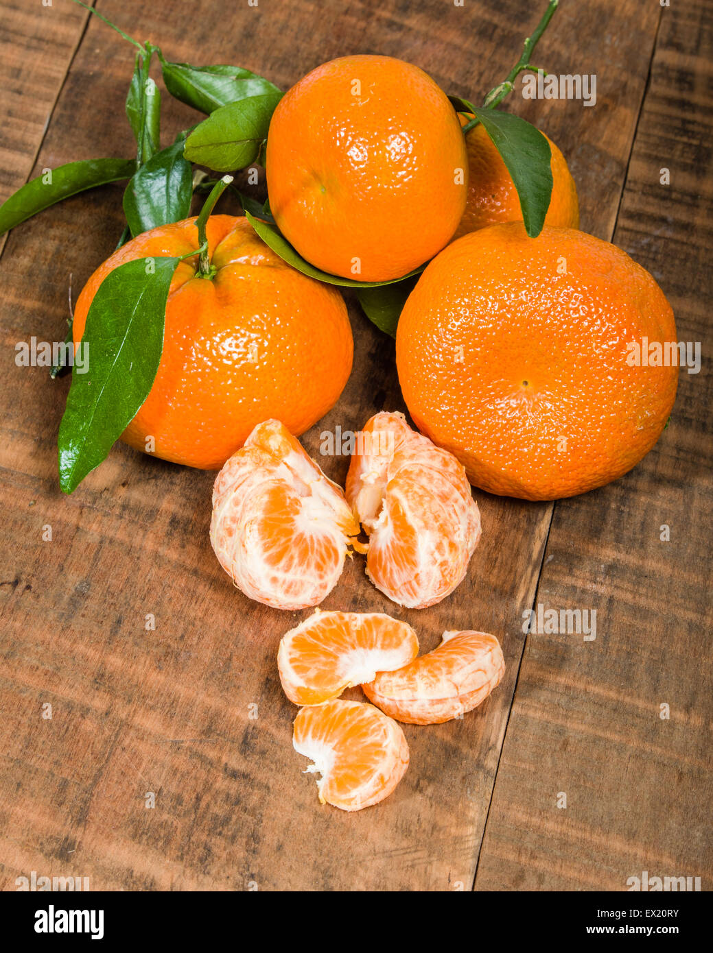 Ripe tangelos with sections of fruit on table Stock Photo - Alamy