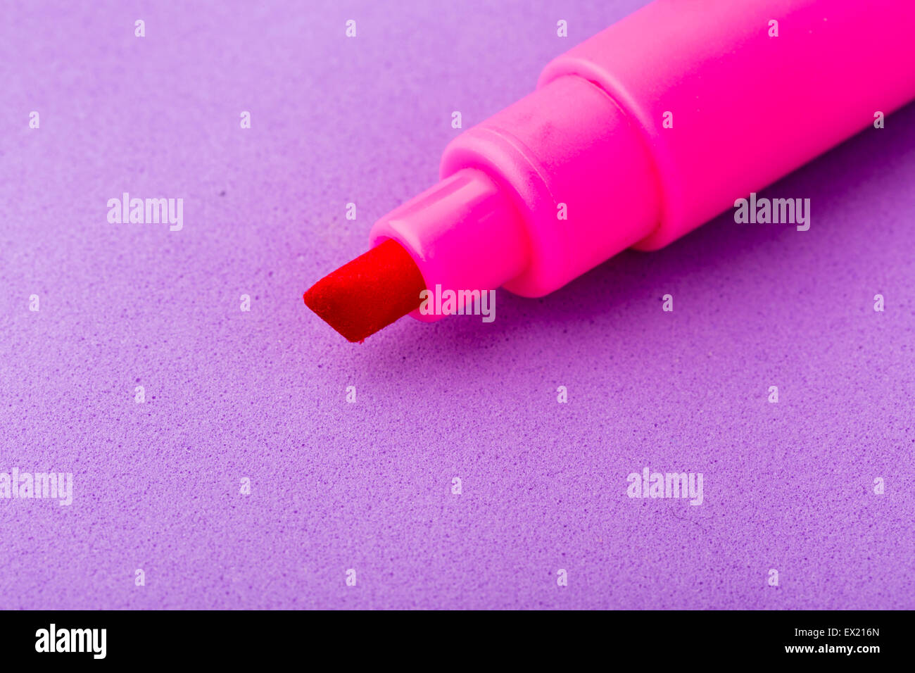 Single pink ink marker isolated on purple background Stock Photo - Alamy