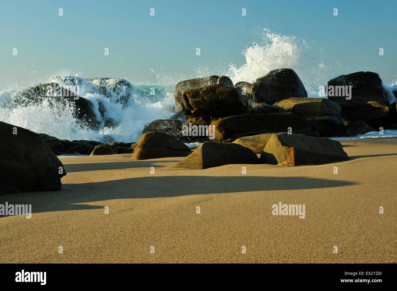 Beautiful seascape scene of white foamy wave washing over rocks on ...