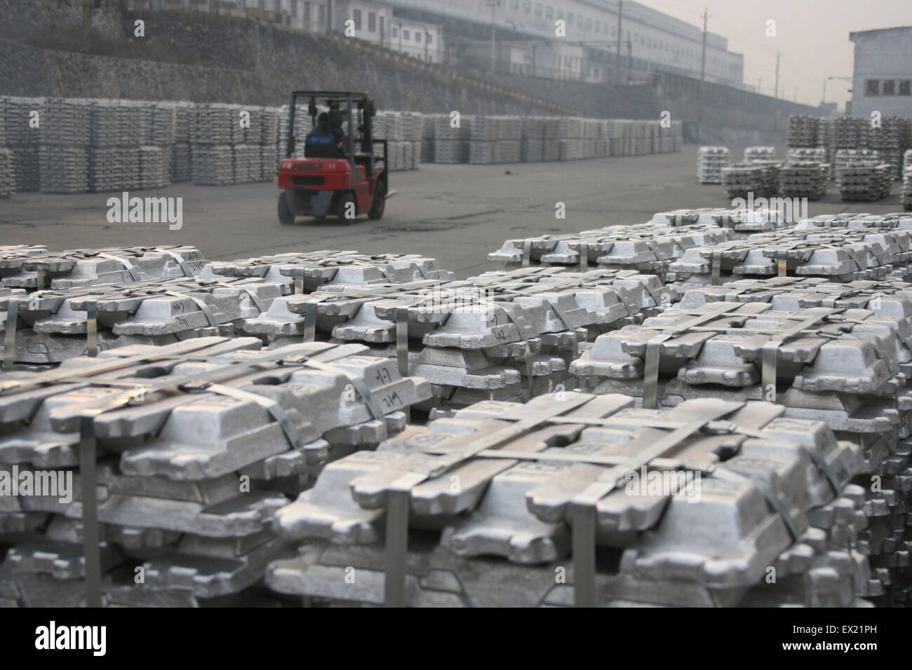 Labourers transport aluminium ingots at a storage of aluminium plant in ...