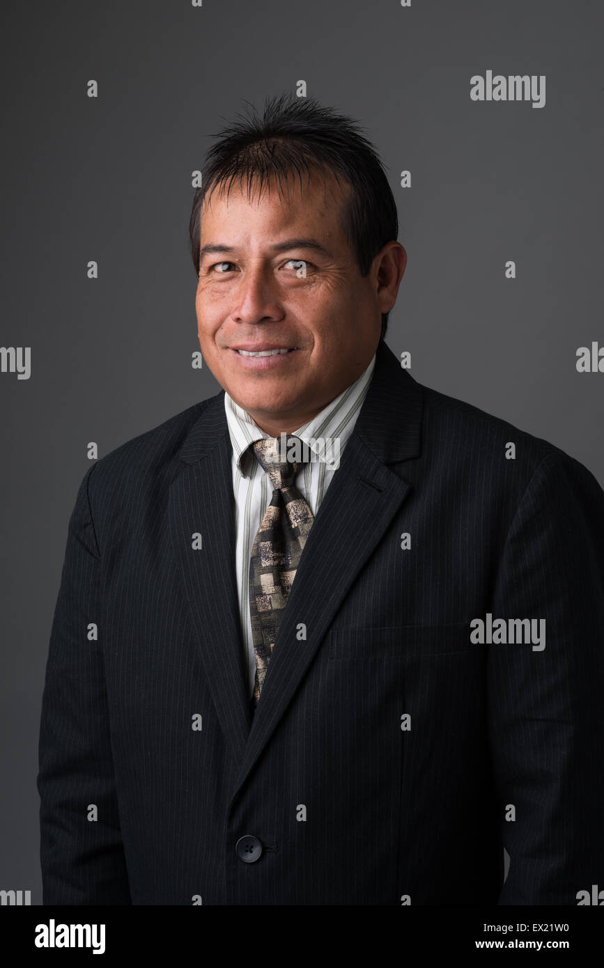 Hispanic business man smiling wearing a business suit posing for a ...