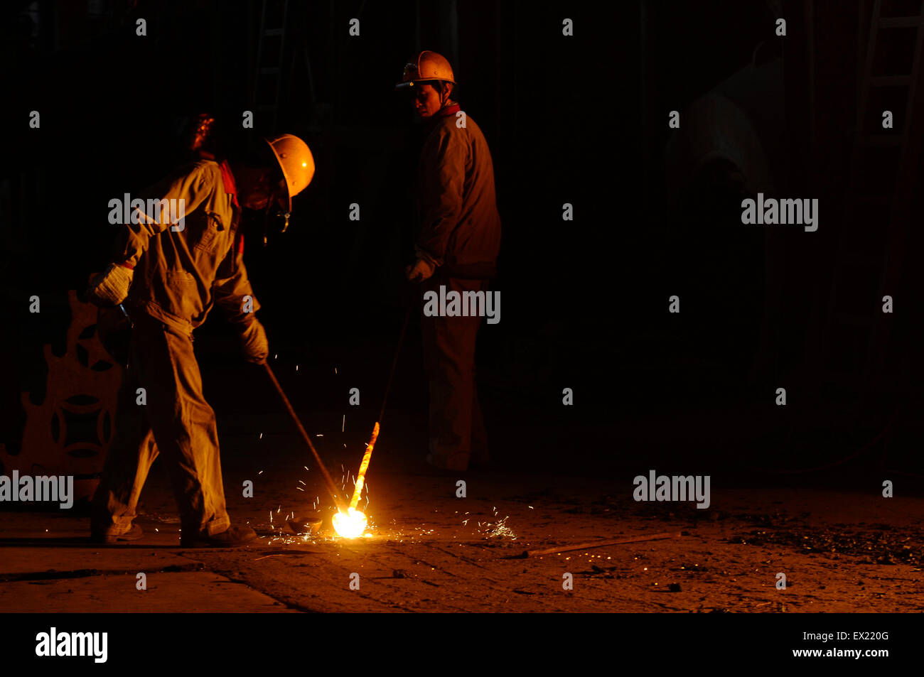Labourers work at a workshop of a steel and iron factory in Changzhi ...