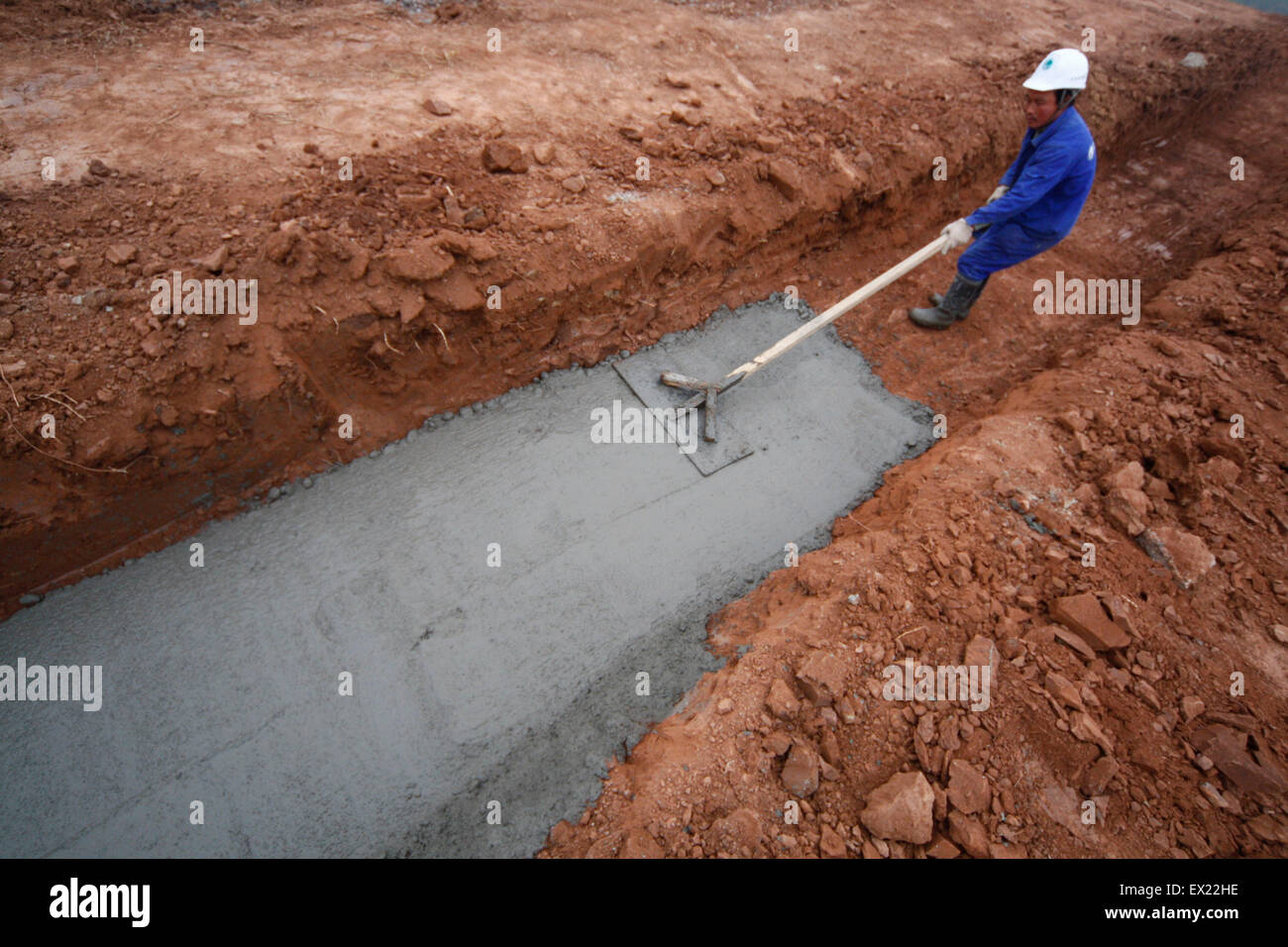 A labourer works at a cosntruction of a transformer substation in ...