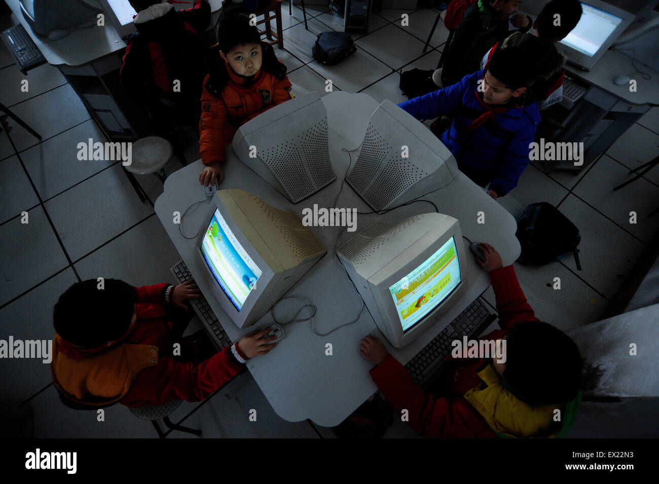 Children use computers at an internet room of a primary school in Hefei ...