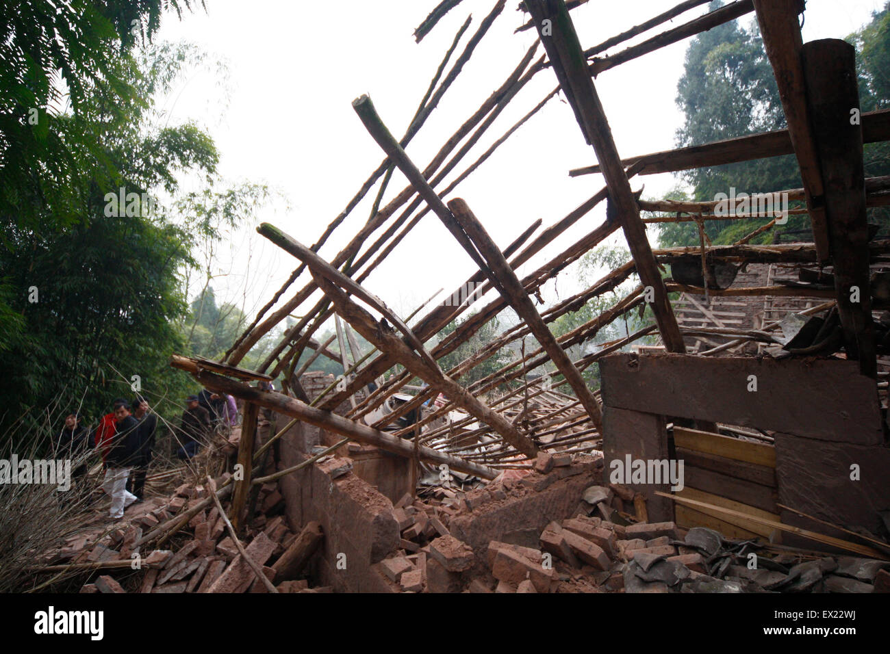 Rescuers search for victims from the debris of collapsed houses after ...