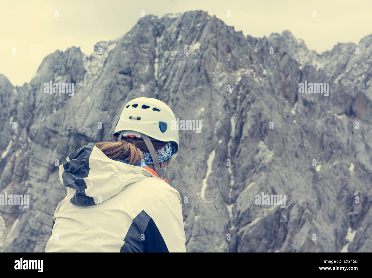 Alpinst looking at mountain wall Stock Photo - Alamy