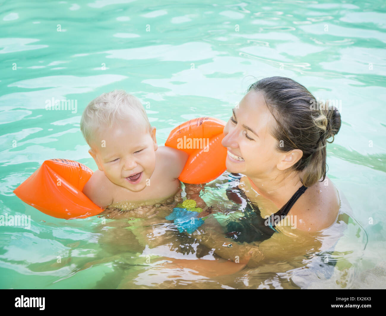 Baby and mother in swimming pool Stock Photo - Alamy