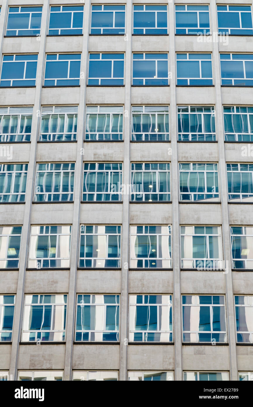 A repetitive grid of reflective office windows in Peter House, a ...