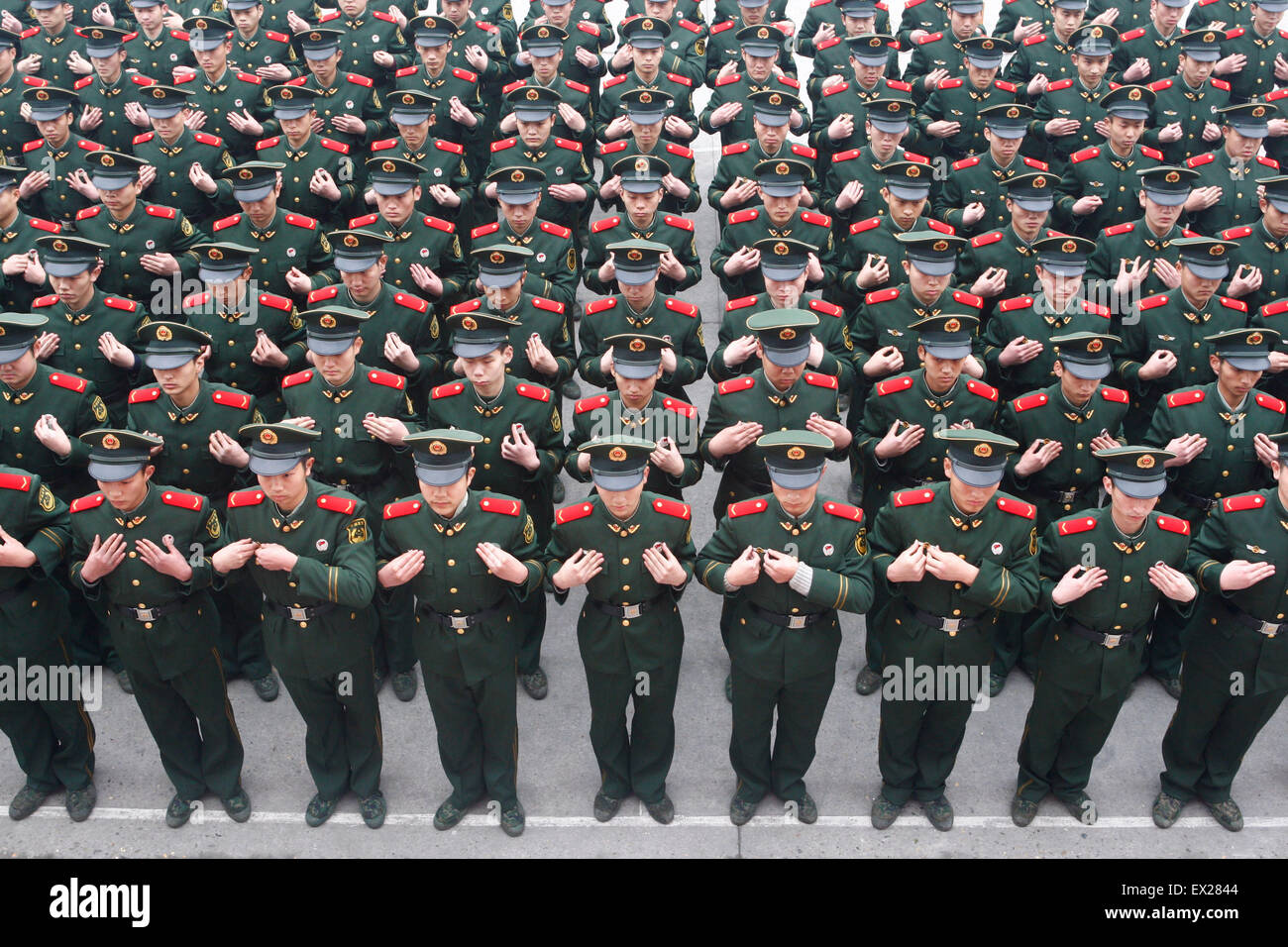 Recruits of the paramilitary police adjust their uniforms during a rank ...