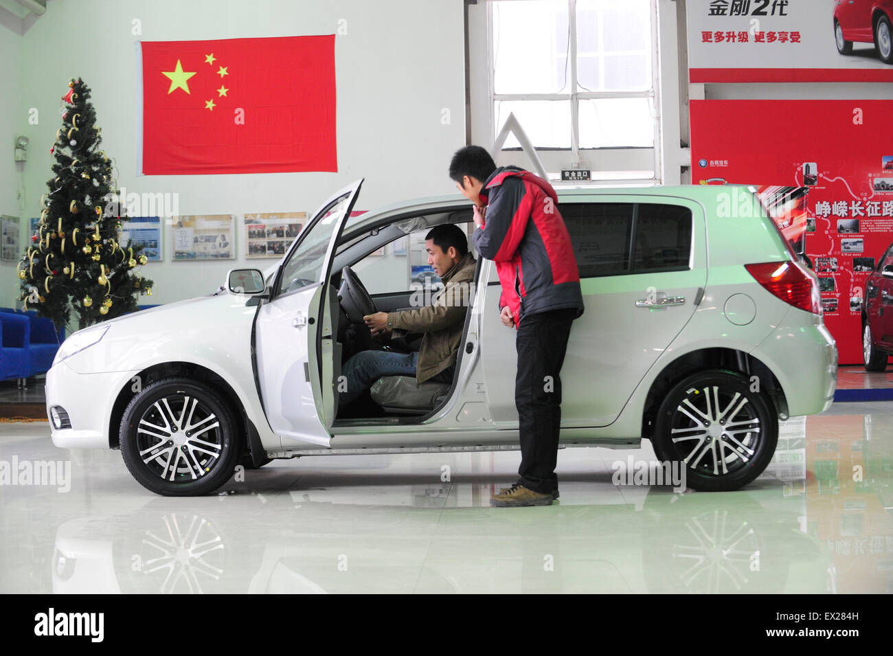 A customer tries a new car of Geely at a Geely flagship store in Hefei ...