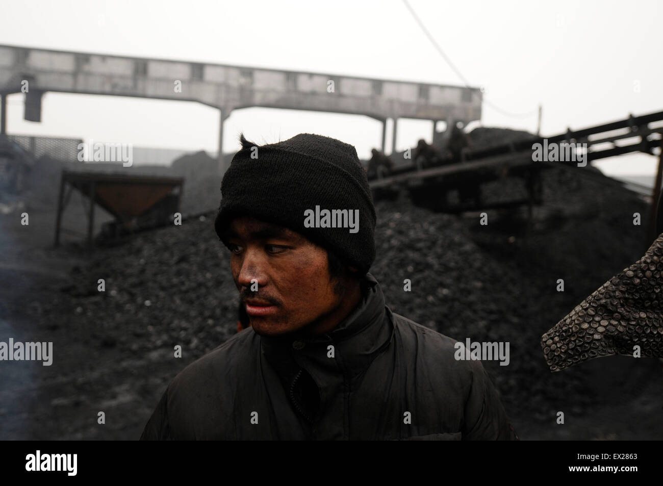 Miners prepare coal for transport at a coal mine site in Changzhi ...