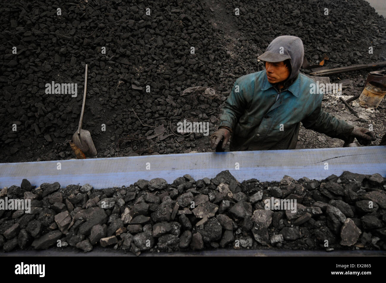 Miners prepare coal for transport at a coal mine site in Changzhi ...