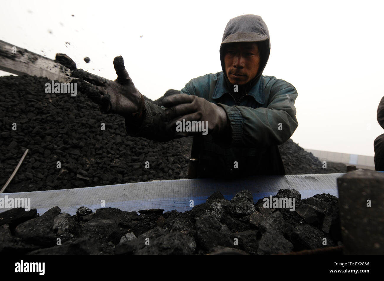 Miners prepare coal for transport at a coal mine site in Changzhi ...