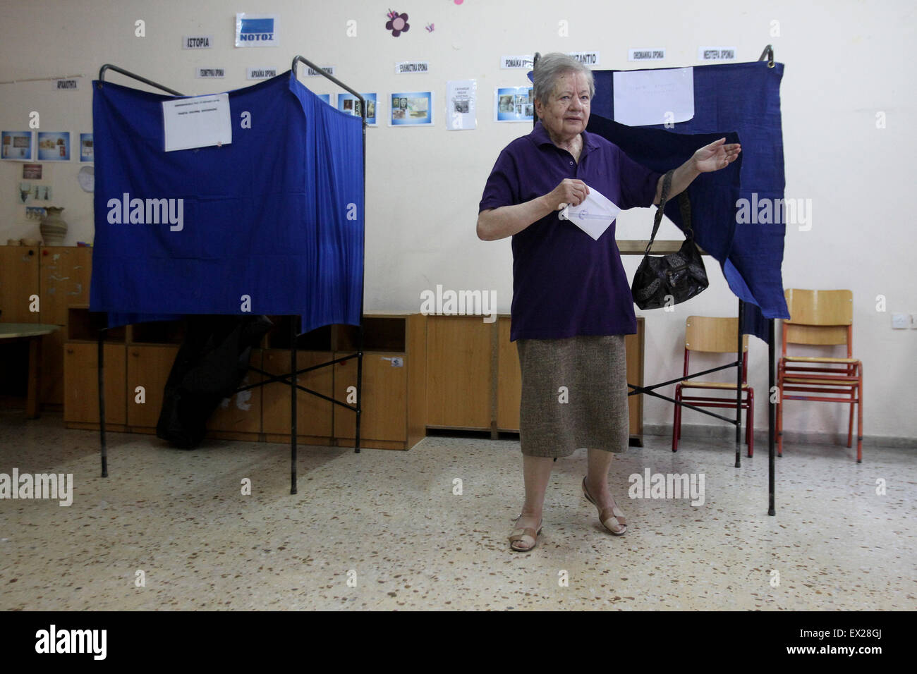 Athens, Greece. 5th July, 2015. A woman leaves the polling booth at a ...