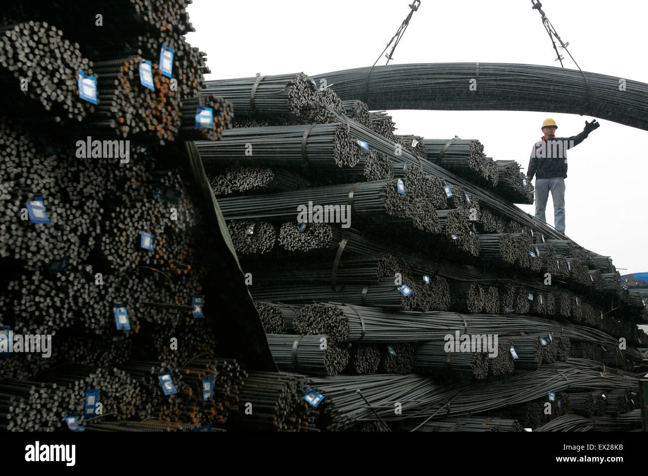 A labourer transoports steel bars at a steel and iron market in Taiyuan ...