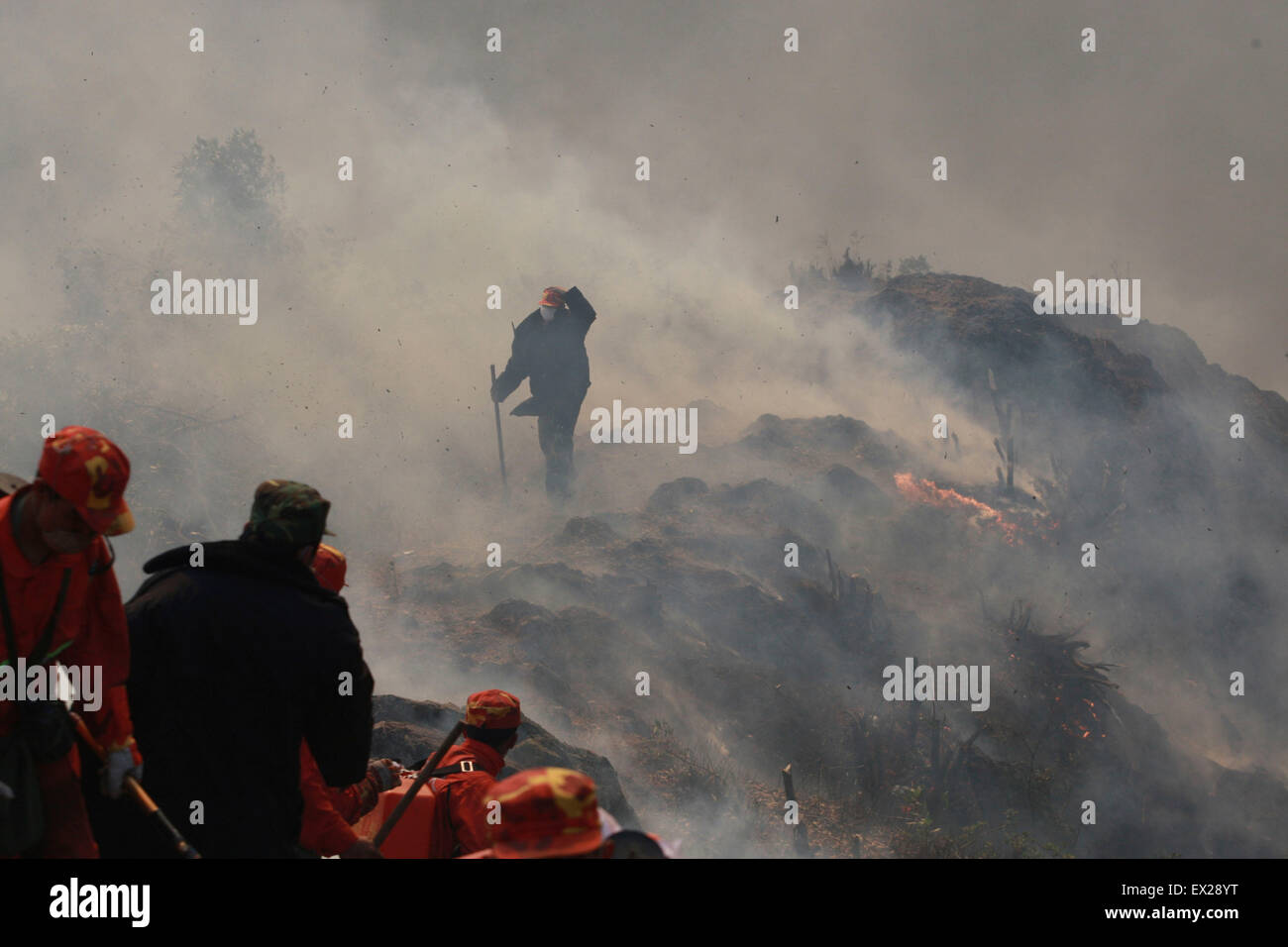Firefighters try to put out fire at the spot of forest fire in Luliang ...