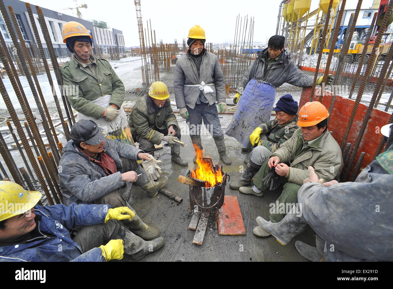 A labourer works at a construction site in Xiangfan, Hubei province ...