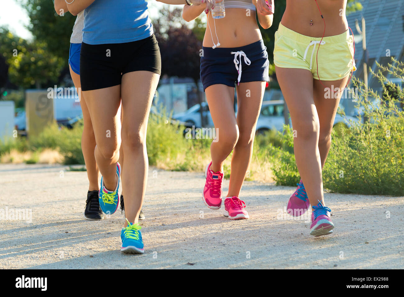 Outdoor portrait of group of women running in the park Stock Photo - Alamy