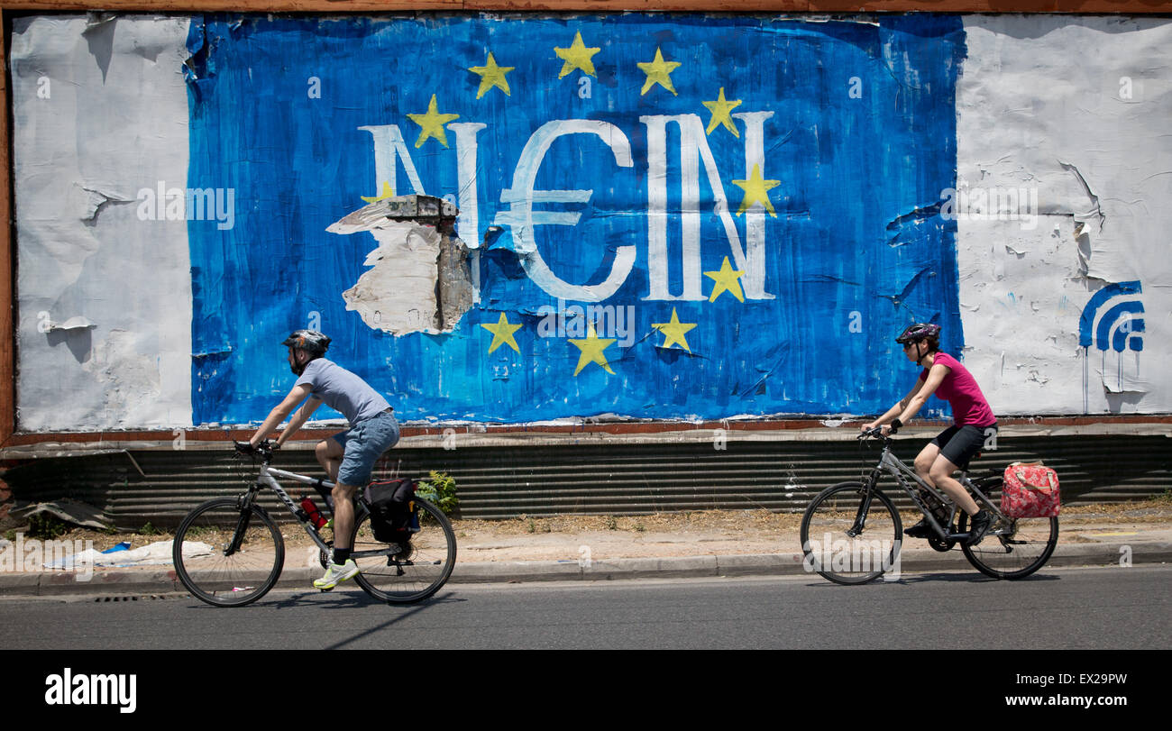 People passes by a graffiti made by street artist N Grams that read ...