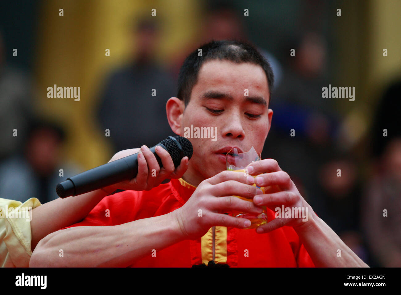 A stunt performer performs eating glass cup for visitors to welcome the ...
