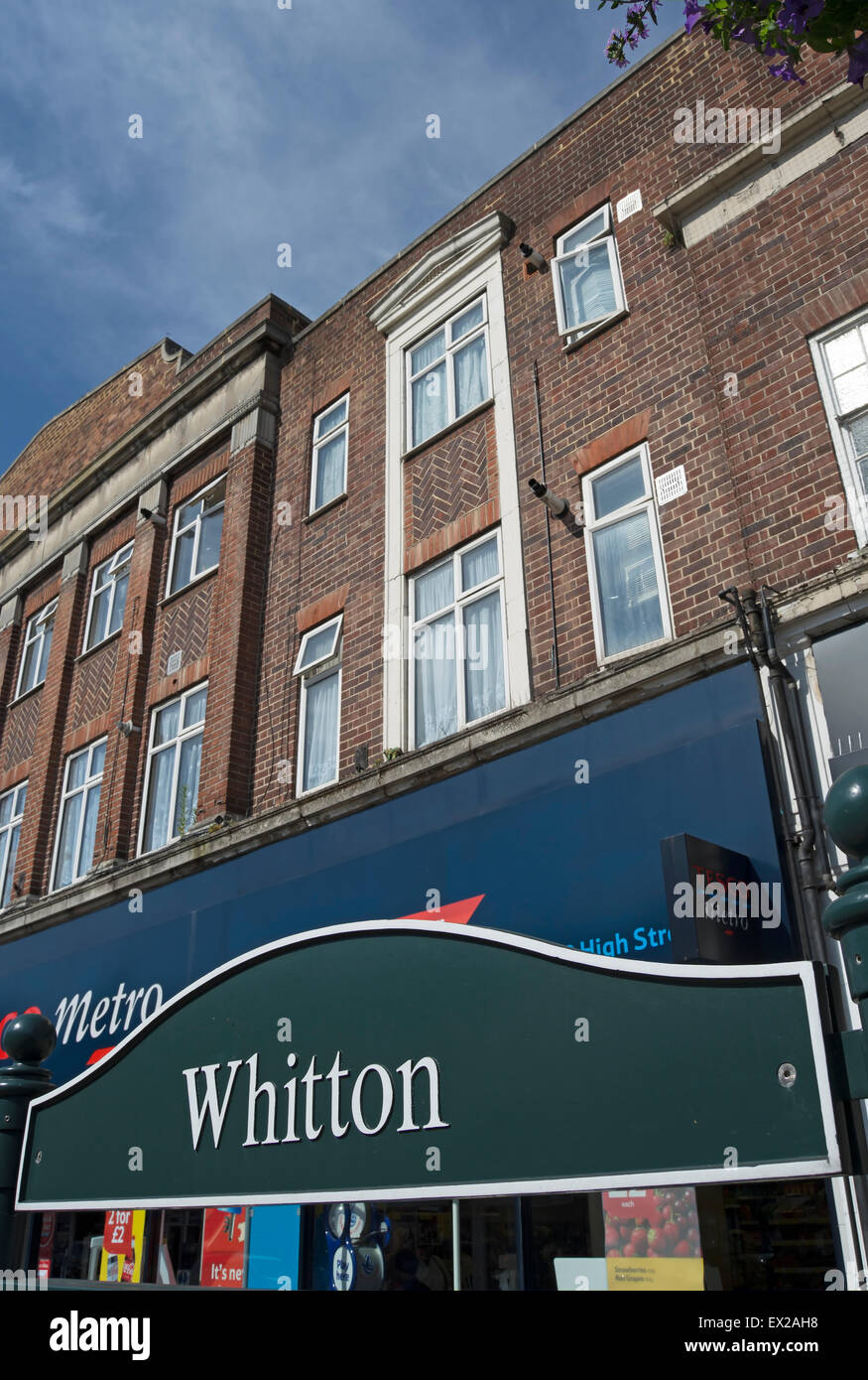 street sign for whitton, in middlesex, england, with high street shops ...