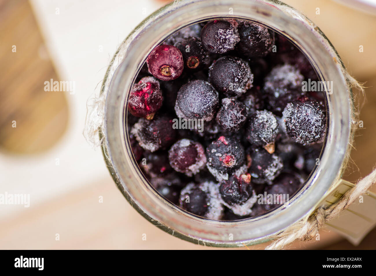 Frozen black currants in a glass jar closeup top view Stock Photo - Alamy