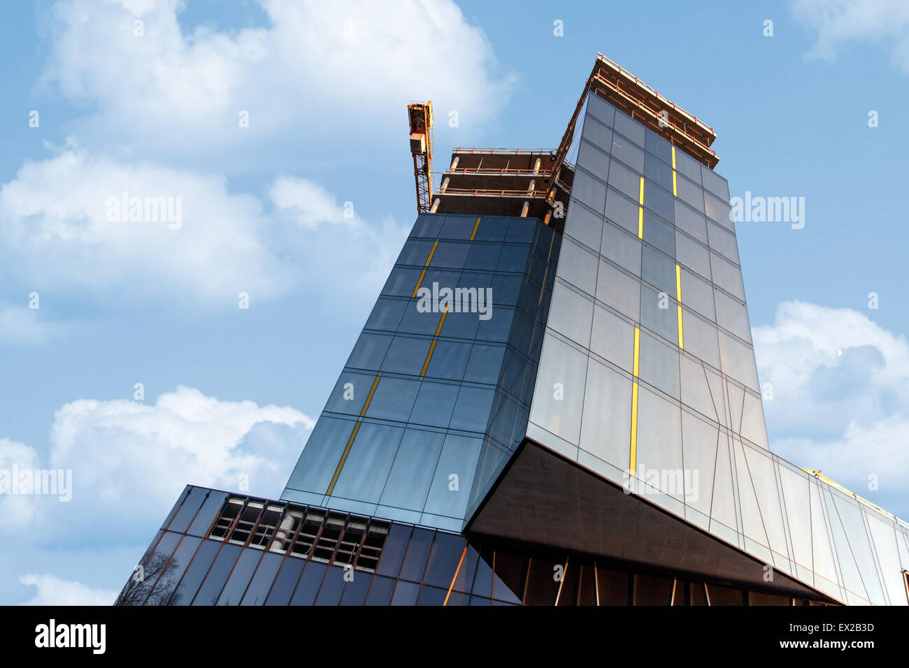 Bottom view of modern glass-lined building construction in worksite ...
