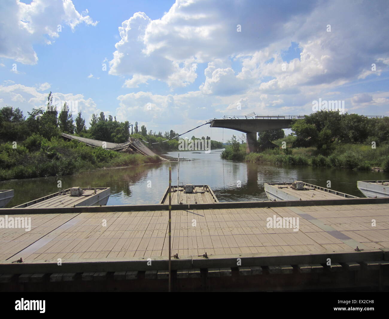 A view of a ponton bridge near a blown up bridge spanning across a ...