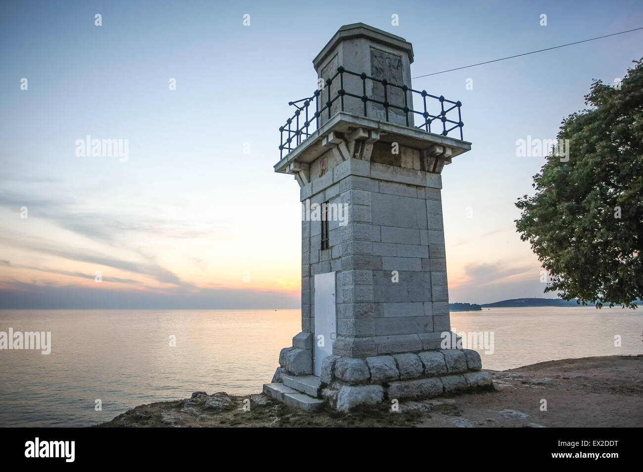 A lighthouse on the shore at sunset in Rovinj, Croatia Stock Photo - Alamy