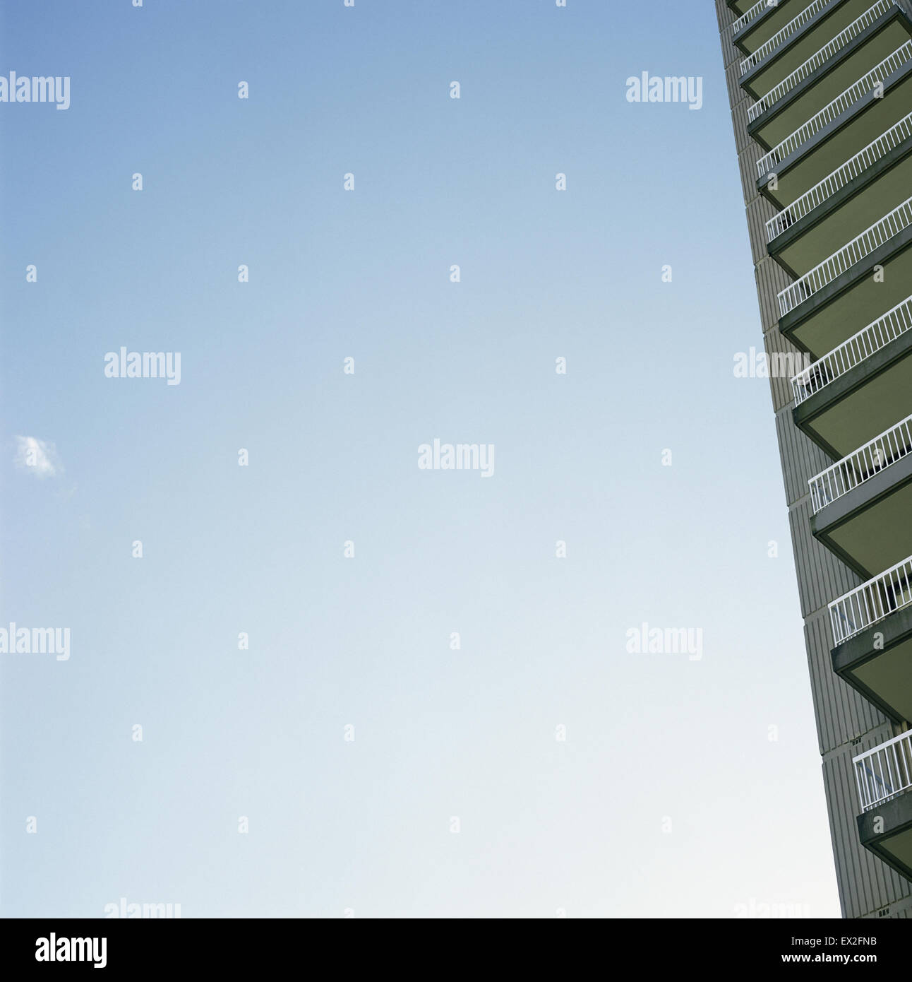 Skyscraper balconies against blue sky Stock Photo - Alamy