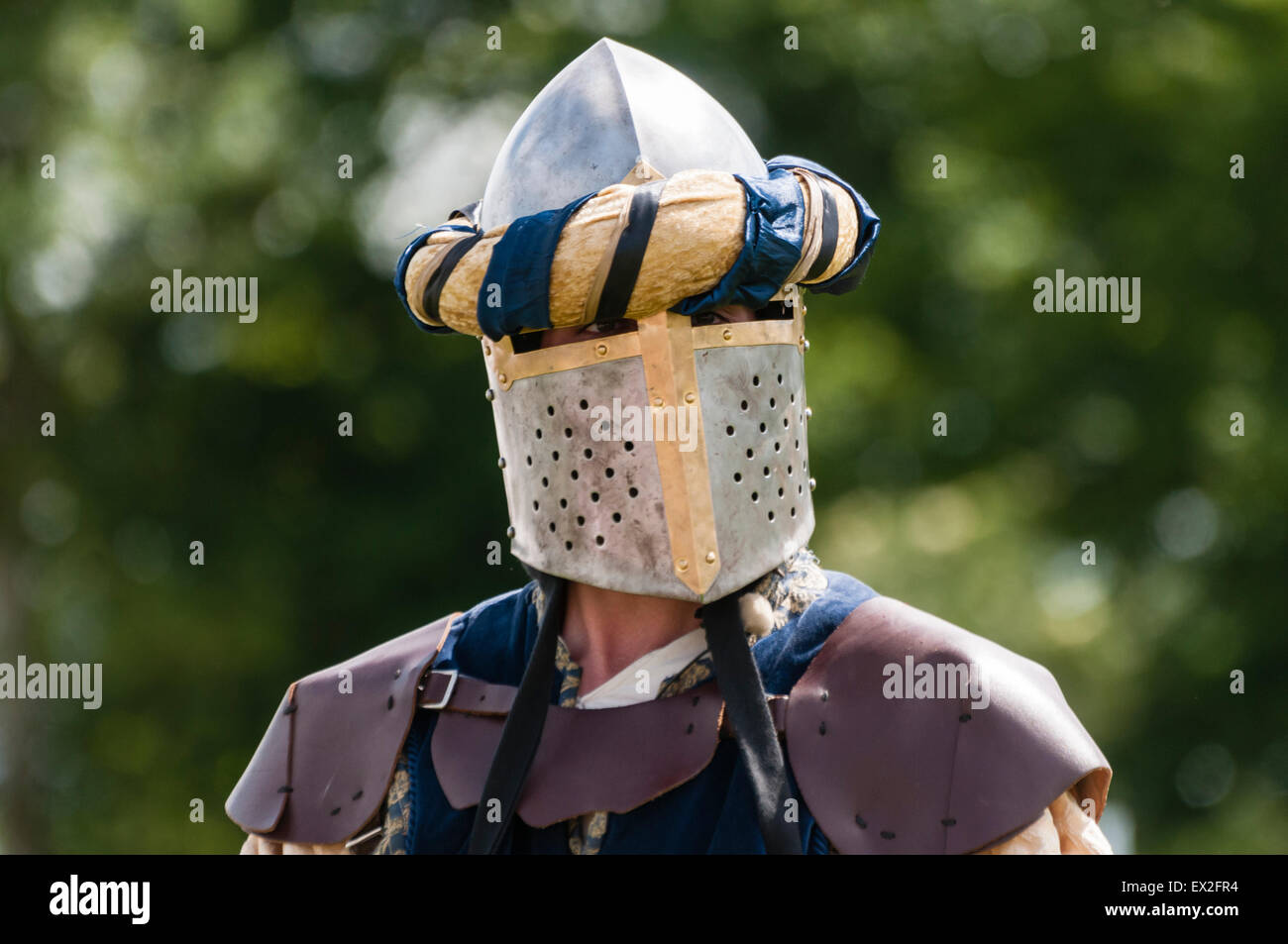 Man wearing a medieval armoured face mask and leather shoulder ...