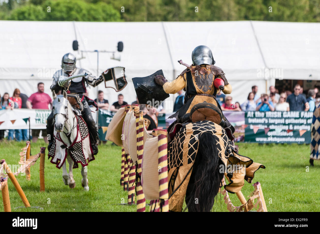 Men dressed as knights stage a jousting battle for a crowd at an ...