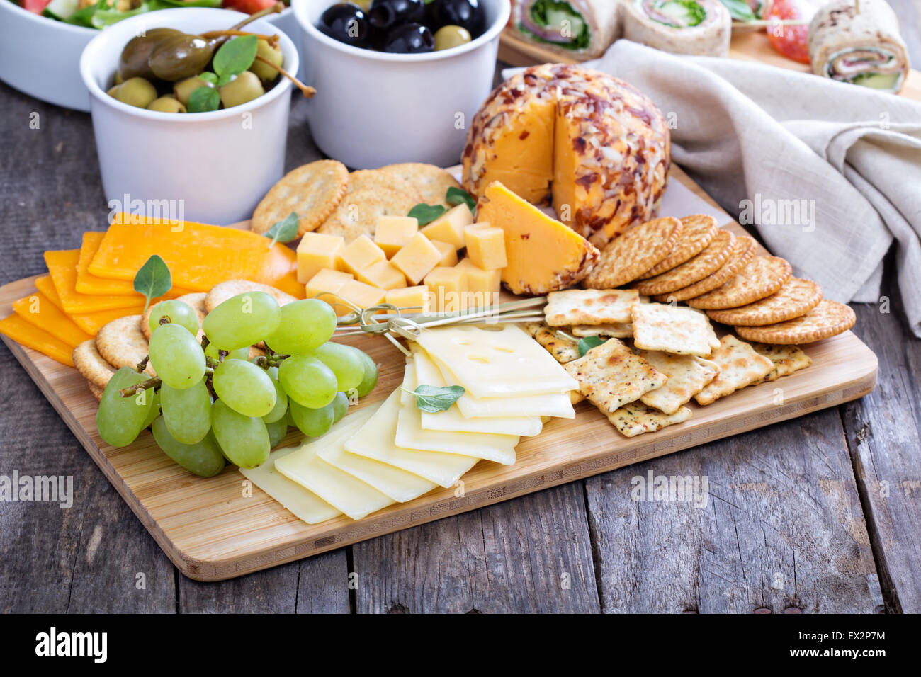 Cheese plate with variety of appetizers on table Stock Photo - Alamy
