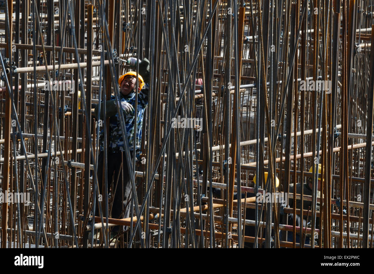 A labourer works on scaffoldings at a construction site in Changzhi ...