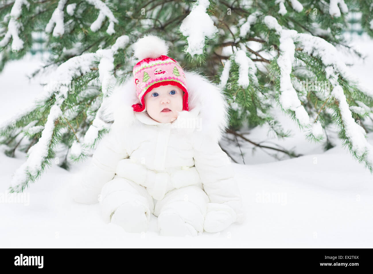 Adorable little baby playing in snow in a winter park Stock Photo - Alamy