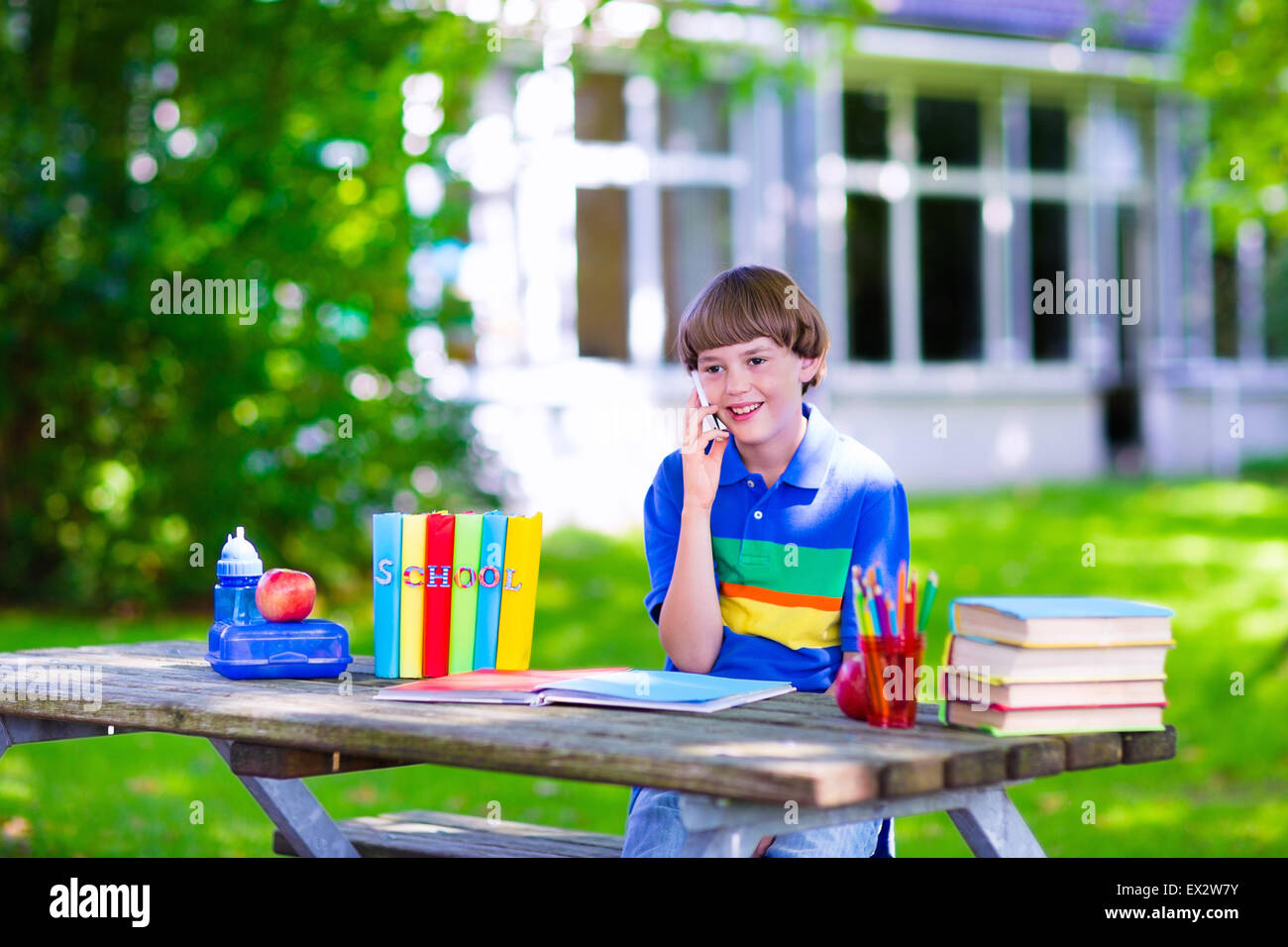 Child in school with telephone. Smart teenager boy studying and ...