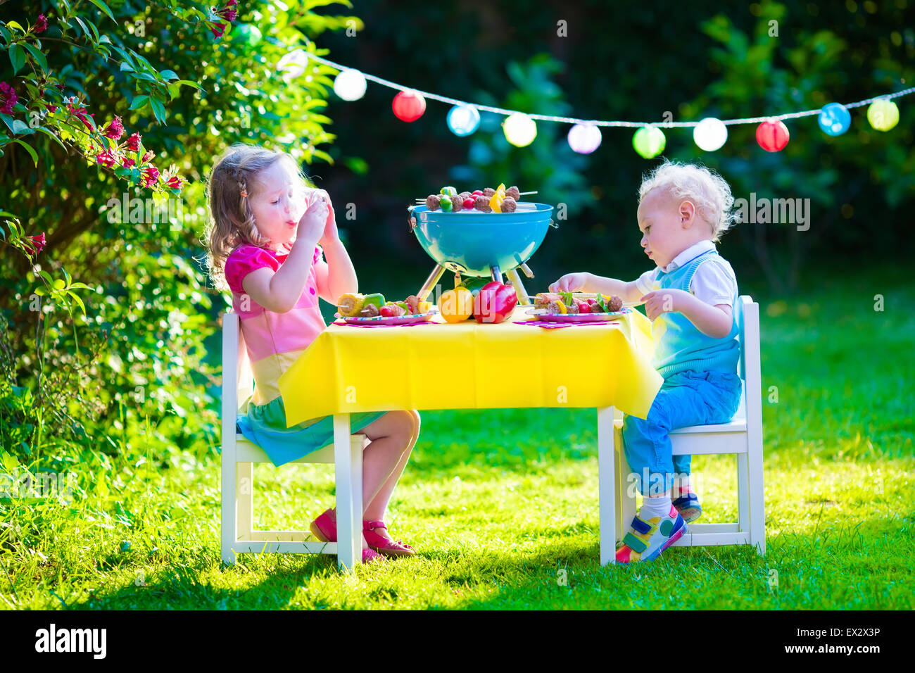 Children grilling meat. Family camping and enjoying BBQ. Brother and ...