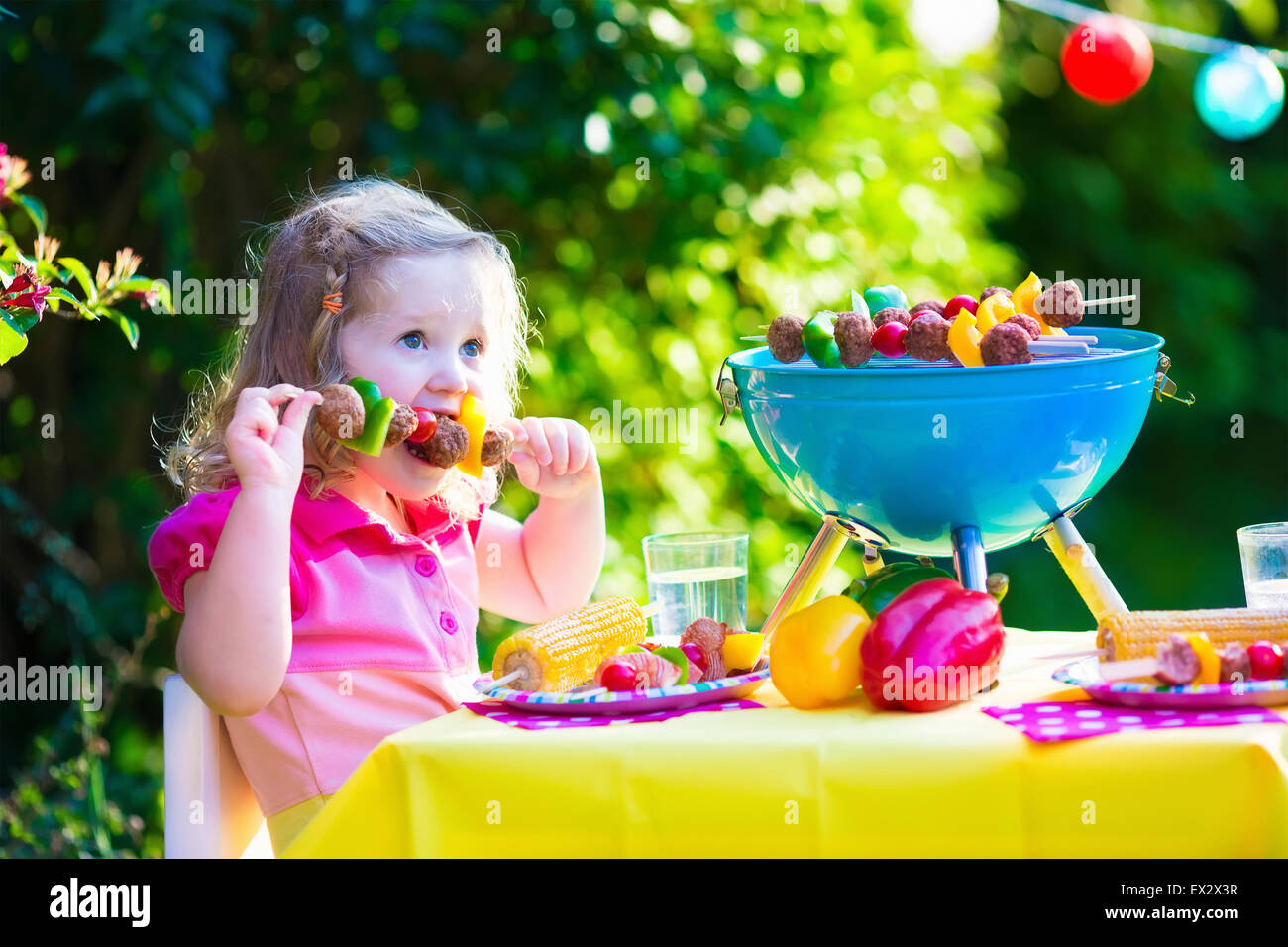 Children grilling meat. Family camping and enjoying BBQ. Little girl at ...