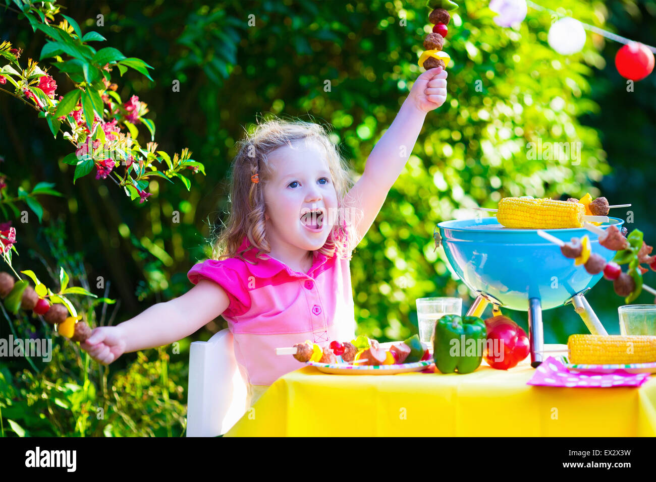 Children grilling meat. Family camping and enjoying BBQ. Little girl at ...