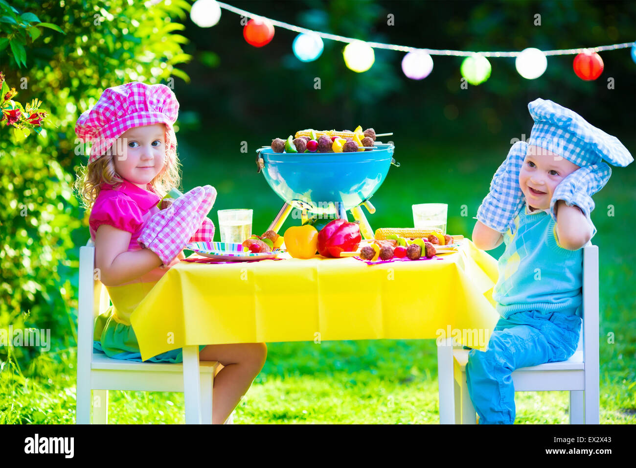 Children grilling meat. Family camping and enjoying BBQ. Brother and ...