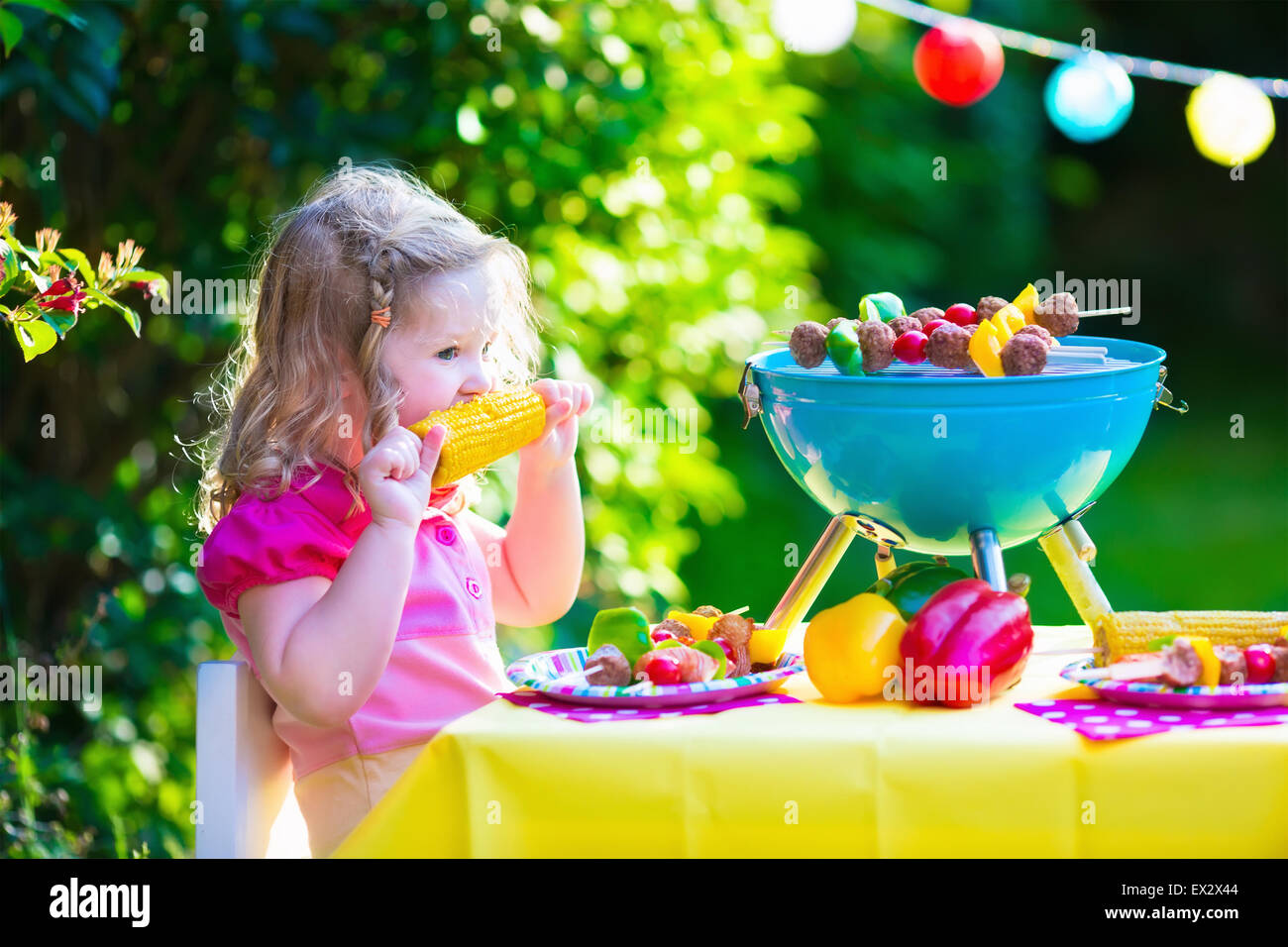 Children grilling meat. Family camping and enjoying BBQ. Little girl at ...