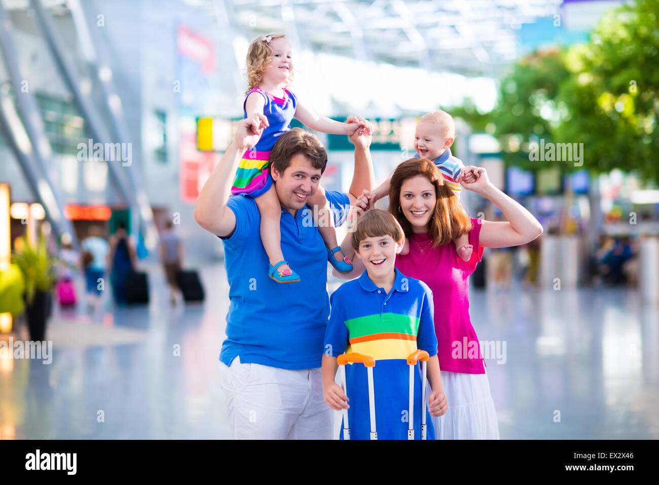 Family traveling with kids. Parents with children at international ...